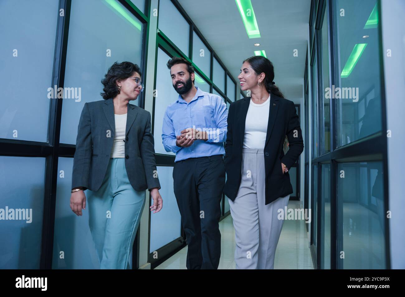group of young indian corporate business people in formal wear having a ...