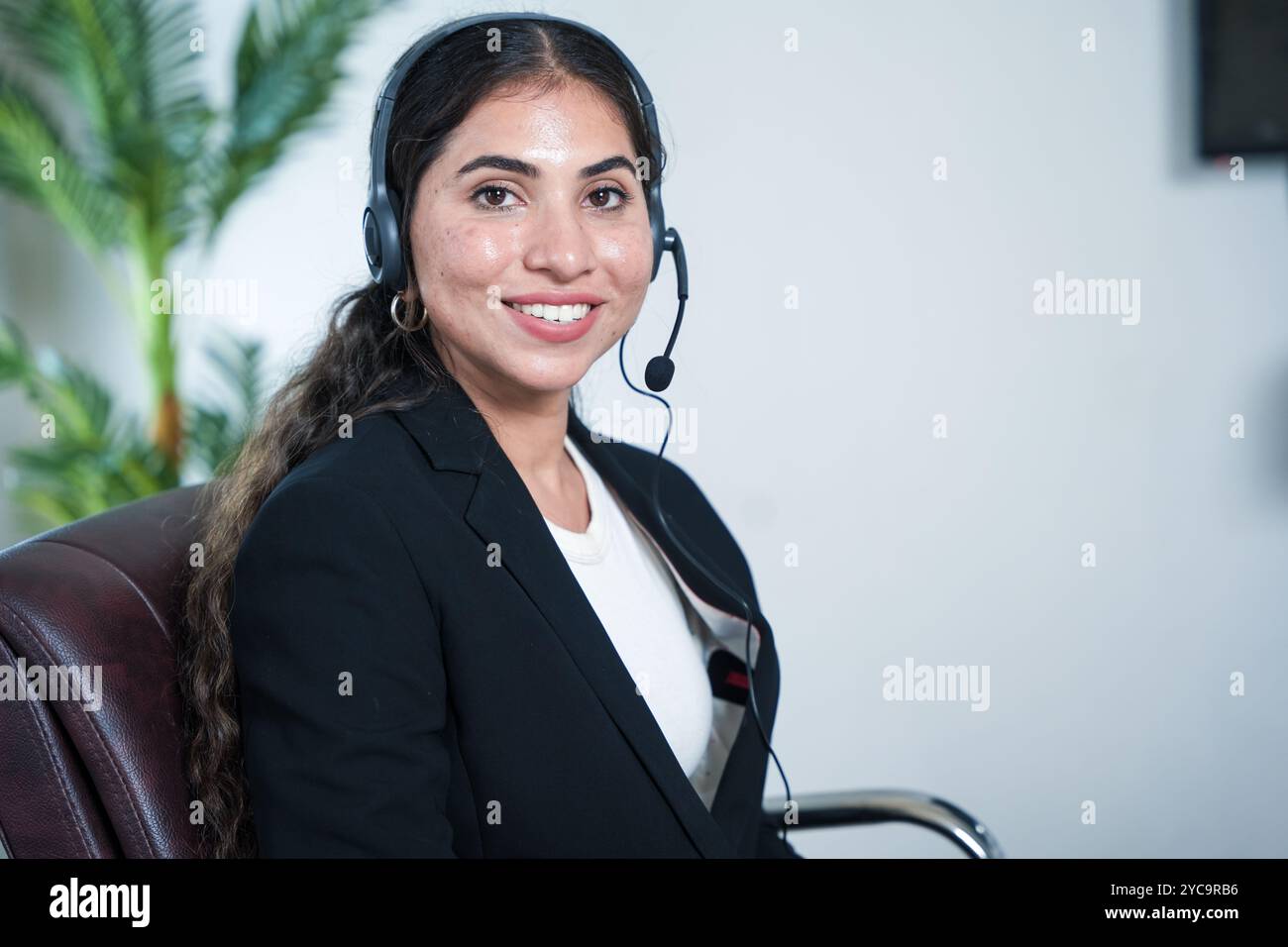 Happy indian service support operator or agent woman wearing headset ...