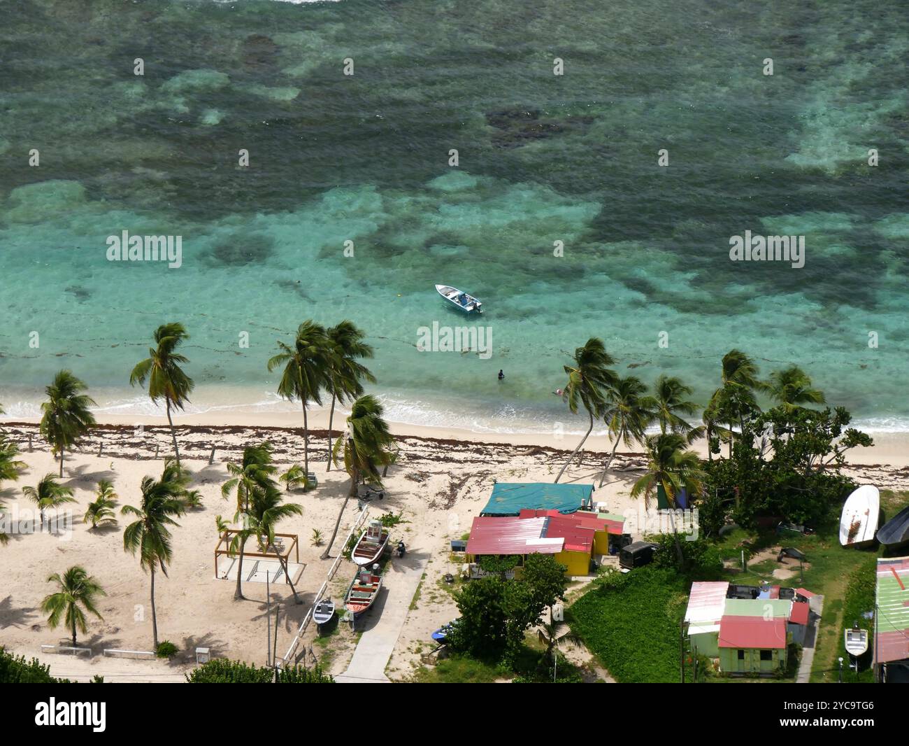 Aerial view of beach with boat and roofs in Desirade island, Guadeloupe ...