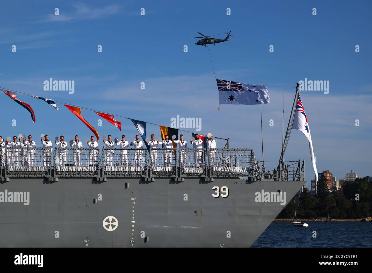 Crew members of the Royal Australian Navy's HMAS Hobart, salute as King ...