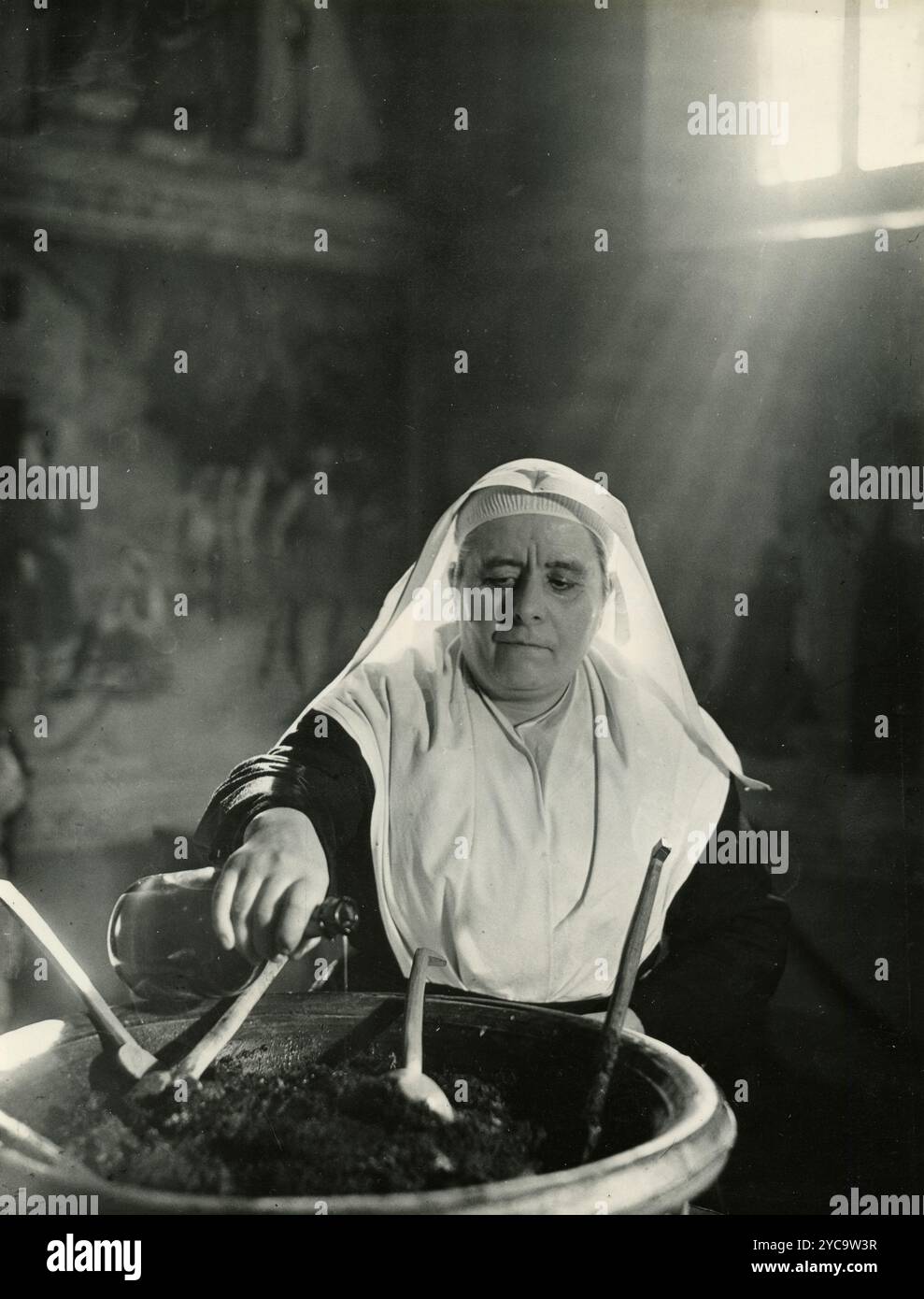 Nun of the Monastery of Oblates to St. Francesca Romana pours blessed ...