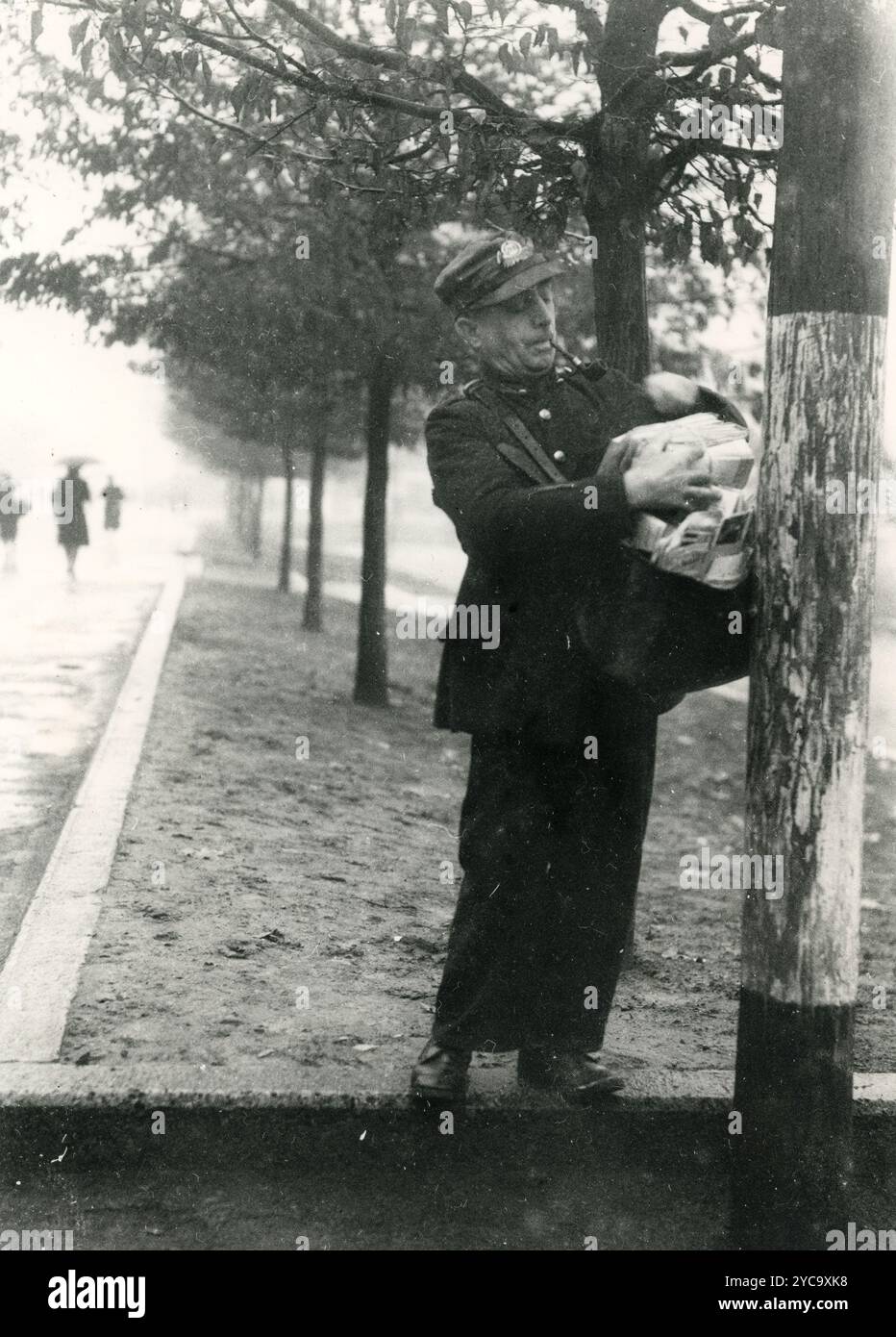 Postman at work in Milan, Italy 1900s Stock Photo - Alamy