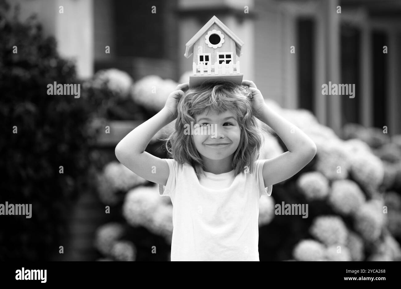 Funny kid hold toy little house. Child making a new dream home. Family ...
