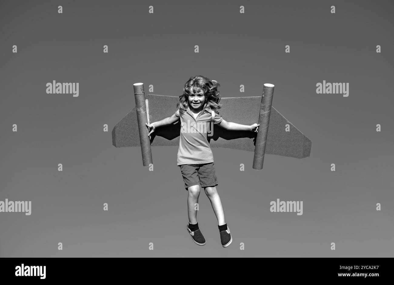 Dreams of travel. Child flying on jetpack with toy airplane on sky ...