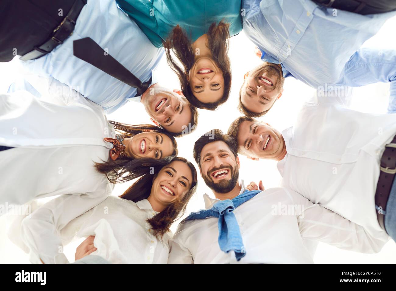 Bottom view portrait of a joyful smiling business people looking down ...