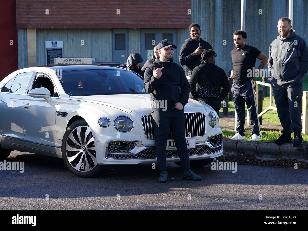 Daniel Dowling-Brooks poses in front of a white Bentley as he ...