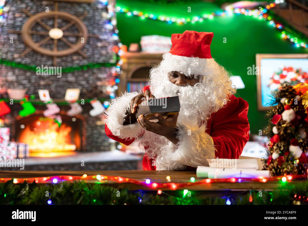 Father Christmas opening a gift box with a light shining bright in it ...