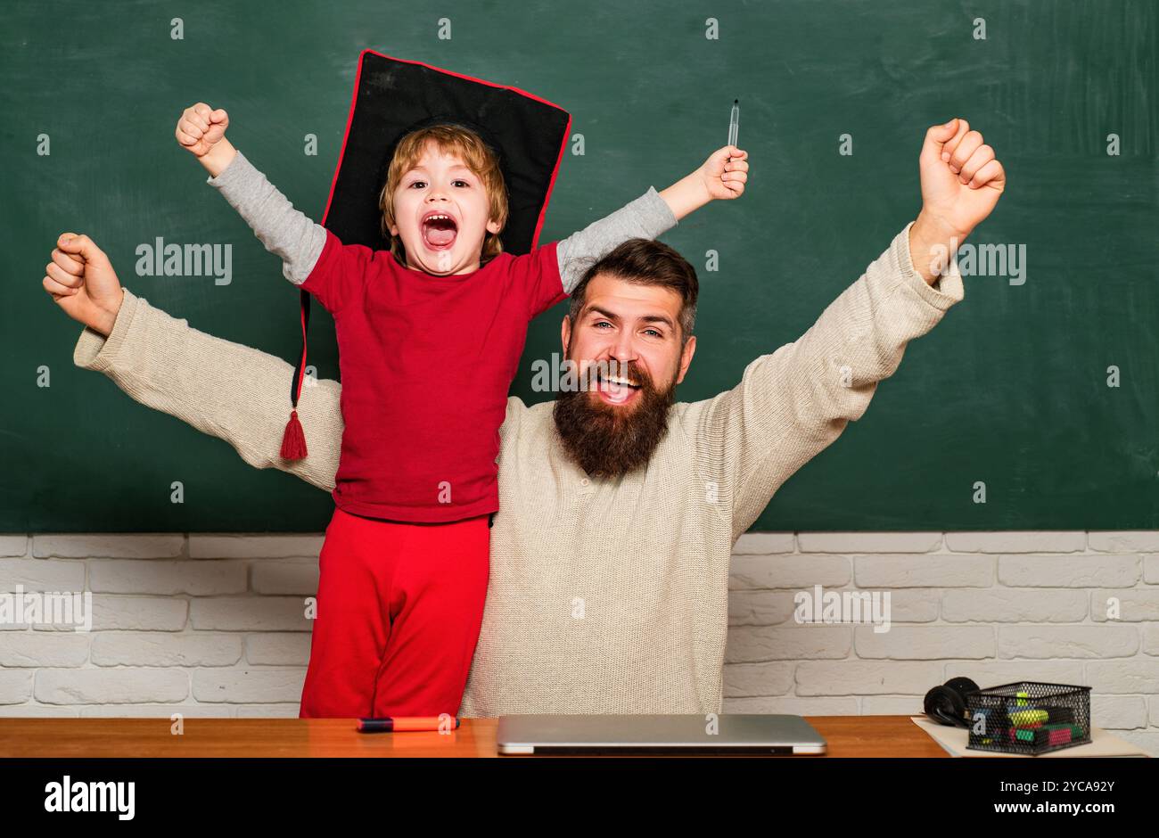 Hooray. Daddy and son raising clenched fists in hooray gesture. Father ...