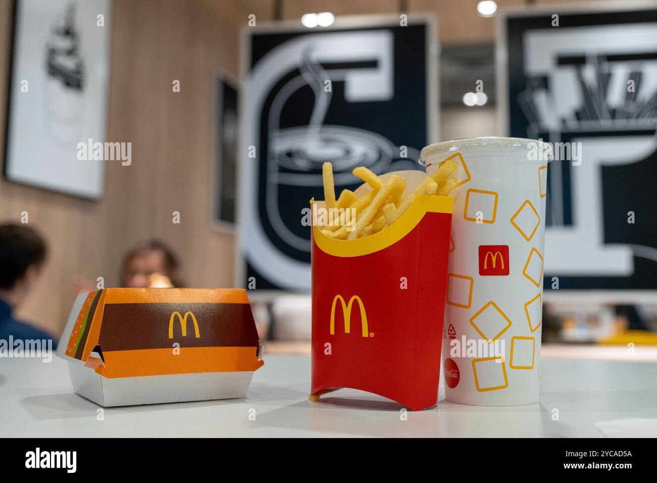 McDonald's food on table in restaurant interior. McDonald's logos on a ...