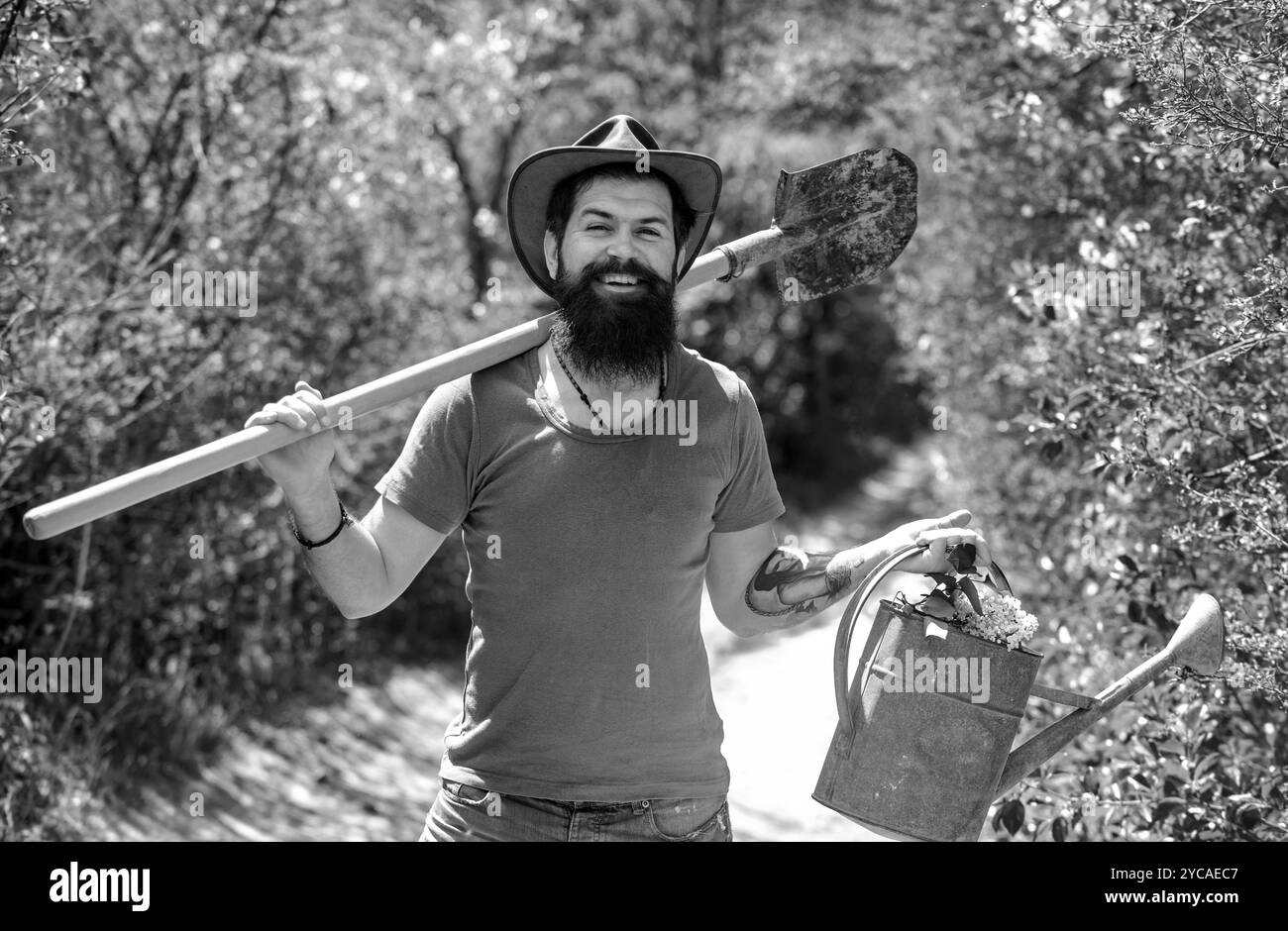 Funny Farmer with Shovel and watering can Stock Photo - Alamy