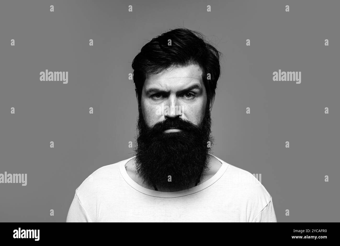 Portrait of confident serious man has beard and mustache, looks ...