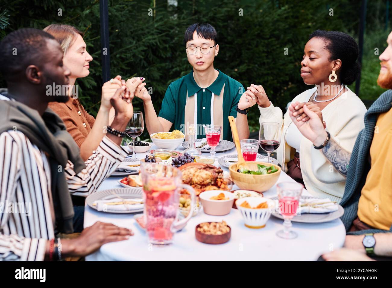 Multicultural group of people celebrating Thanksgiving together and ...