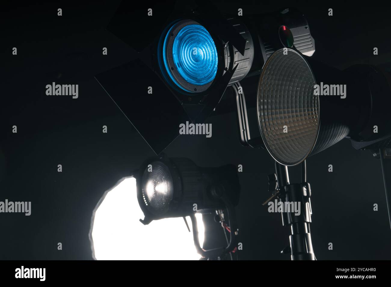 Multiple studio lights are arranged in a dark setting, showcasing ...