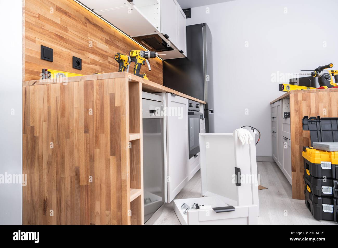 Renovation work is underway in a modern kitchen featuring sleek ...