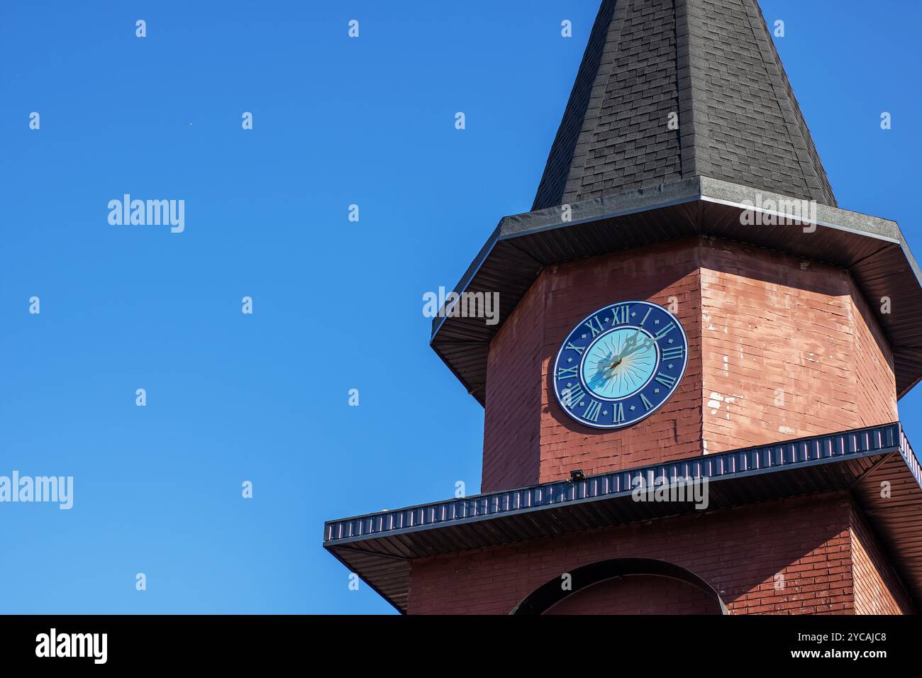 A breathtaking and stunning clock tower that features a vibrant blue ...
