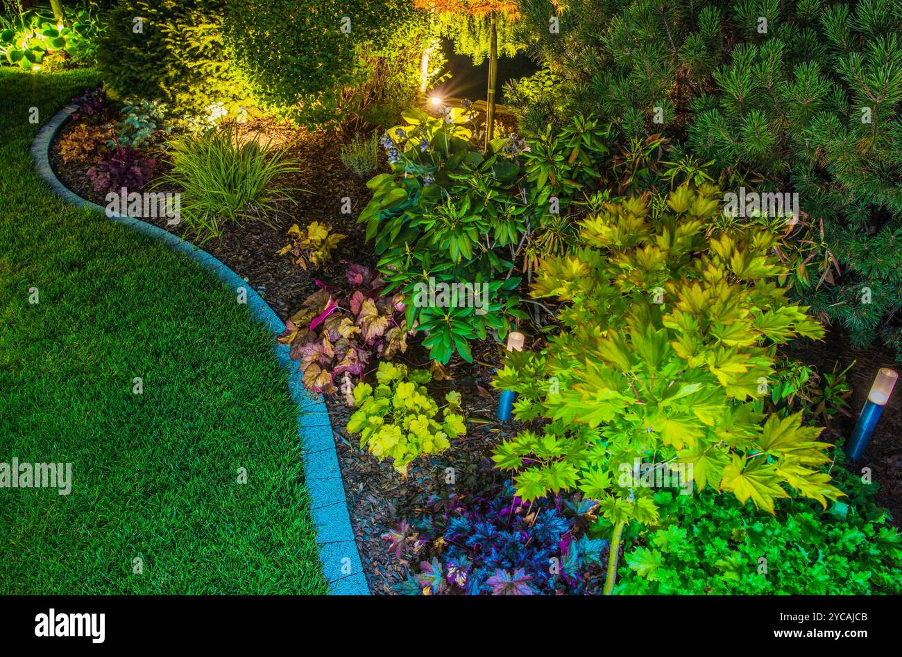 The garden features a variety of colorful plants and shrubs, enhanced ...