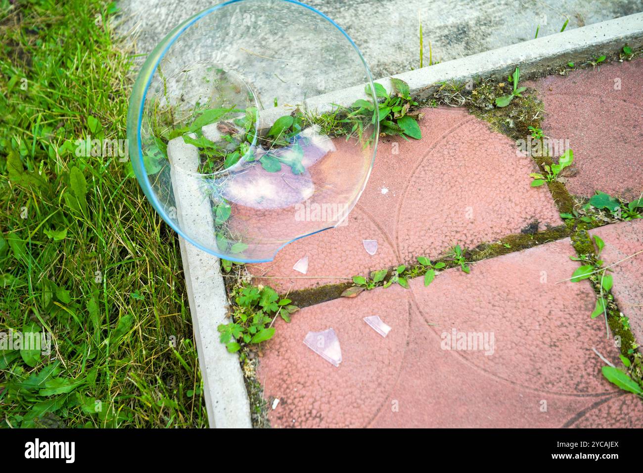 accidentally broken round glass bowl abandoned on the tiled path Stock ...
