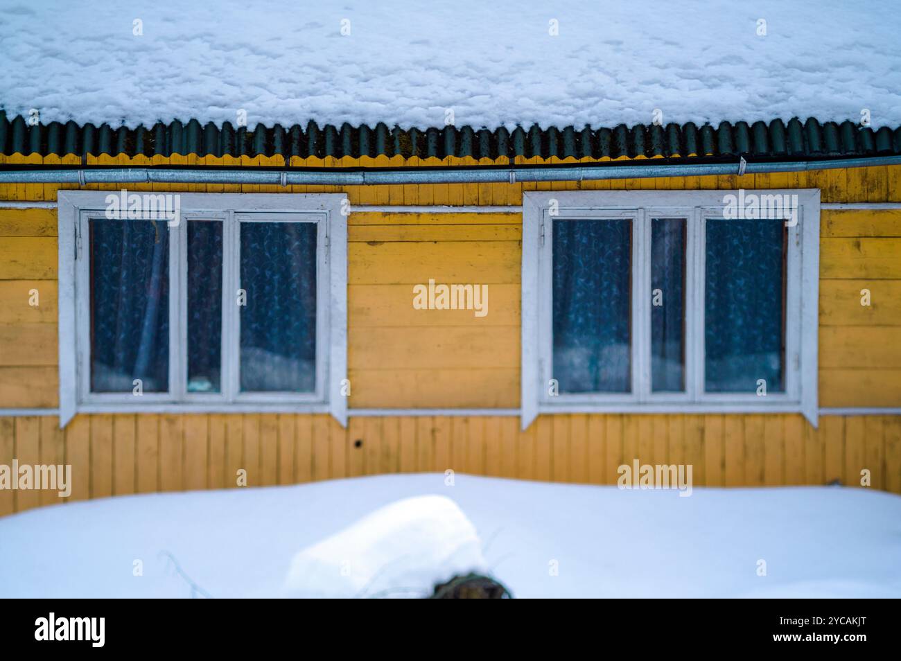 a wooden house buried under snow up to the windows, winter scene Stock ...