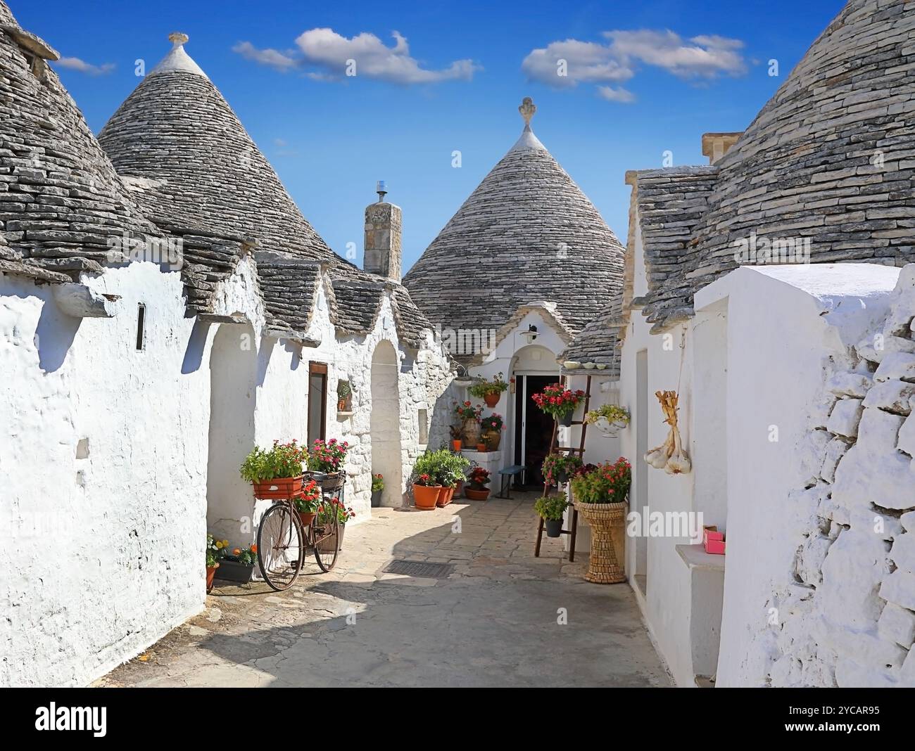 Traditional Apulian Trulli houses - dry stone huts with a conical roof ...