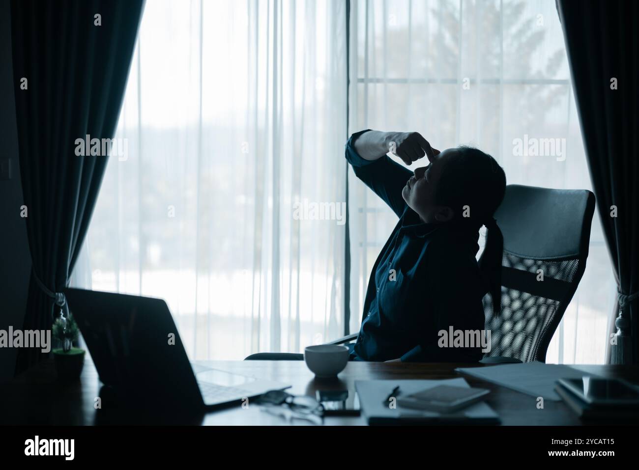 Businesswoman, stressed and sleepy female, sat in her office, feeling ...