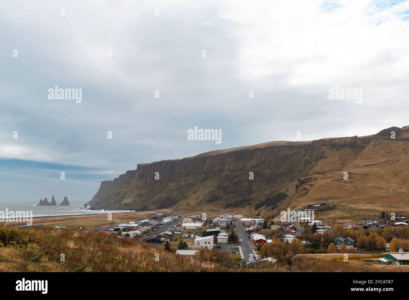 View across Vik village towards Reynisdrangar basalt sea stacks on the ...