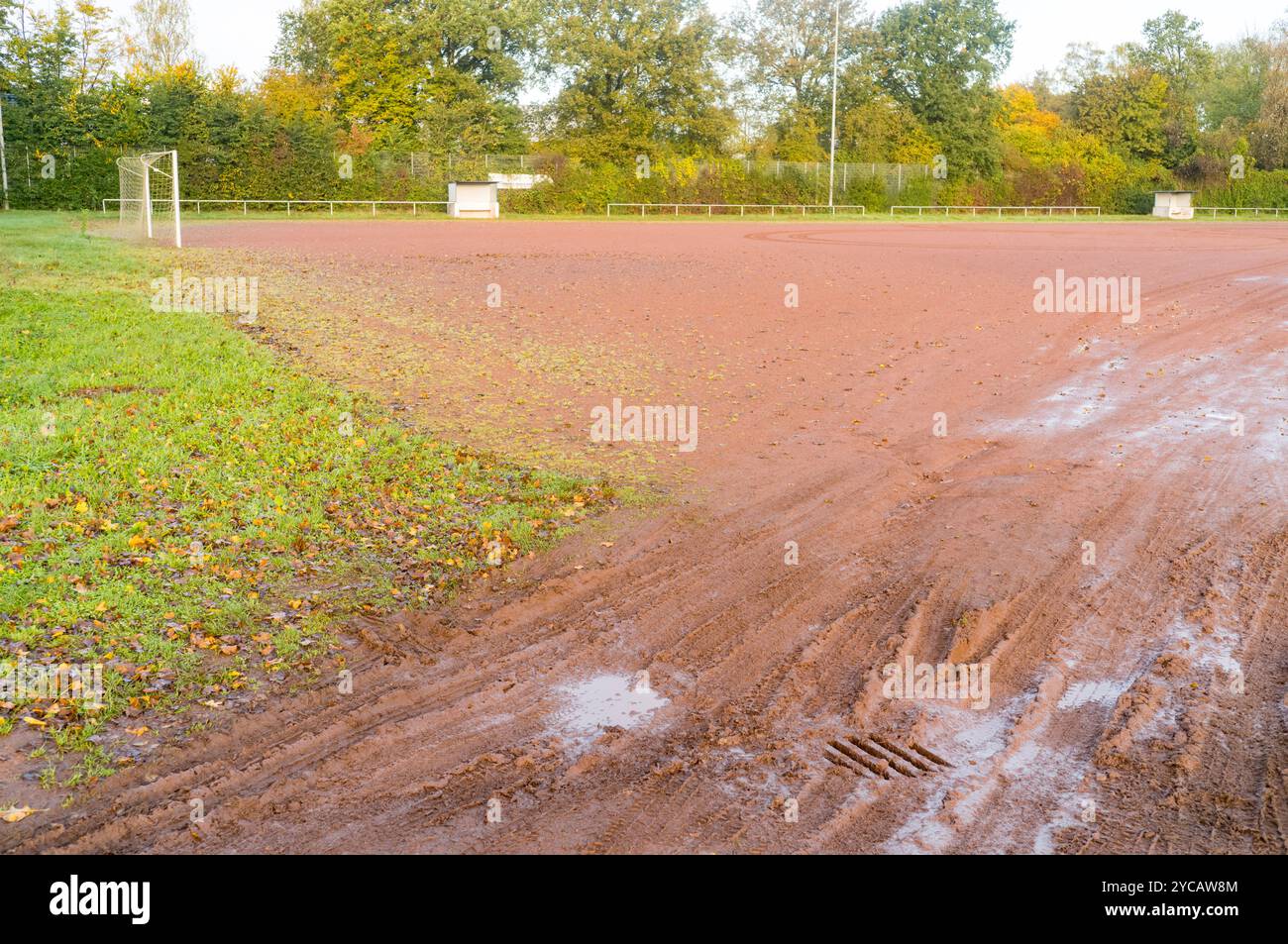 Empty muddy soccer field after the rain showing tire tracks Stock Photo ...