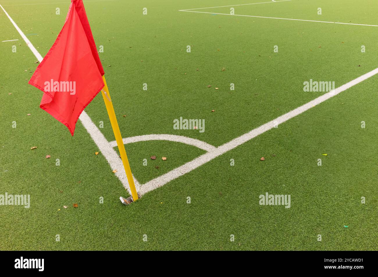 Red corner flag standing on a green soccer field with white lines Stock ...