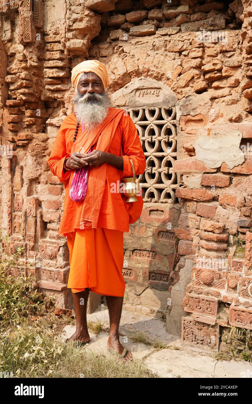 A sadhu poses before a dialopted terracotta mandir of Baidyapur. East ...