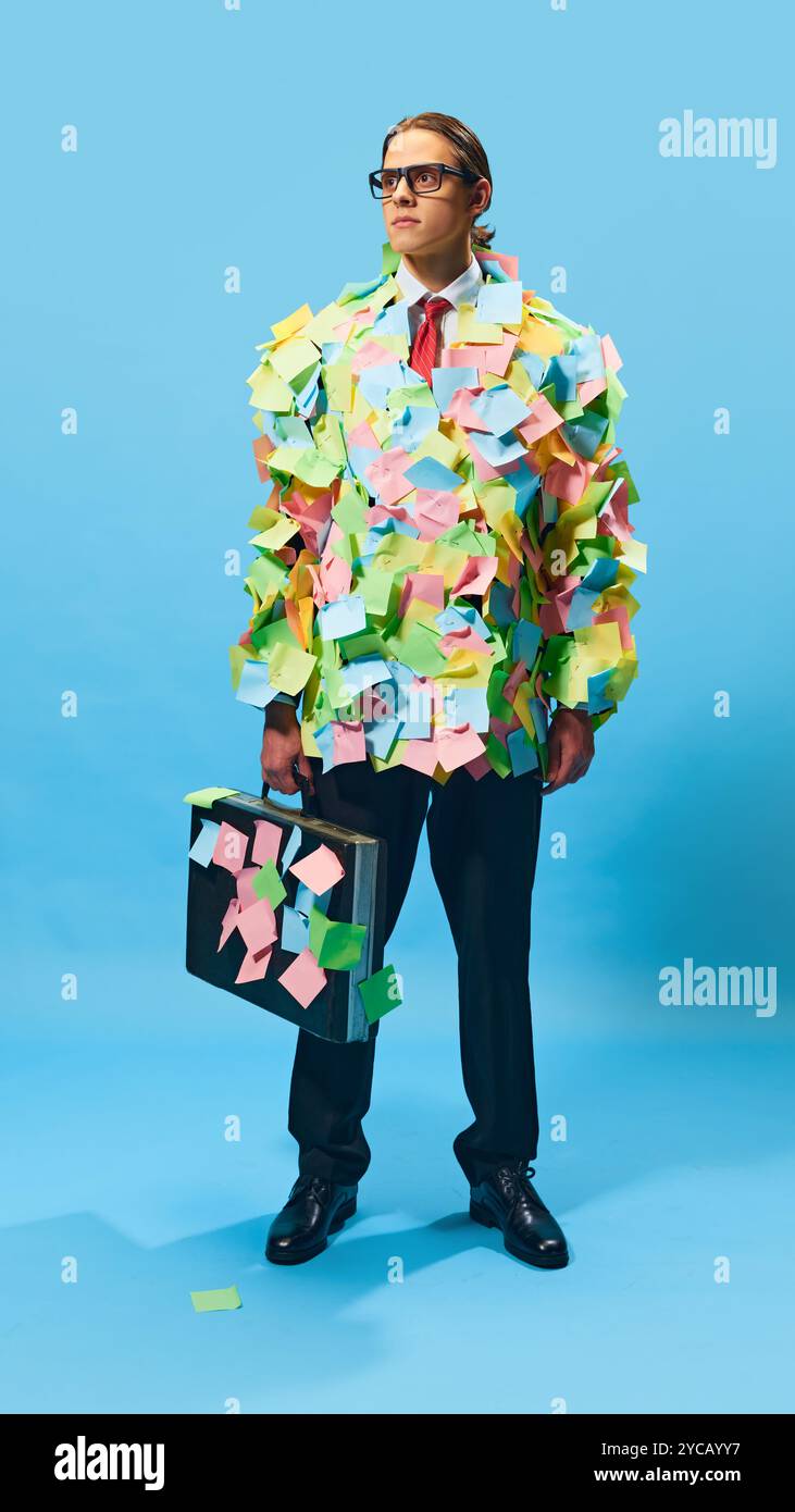 Determined office worker covered in sticky notes. Young man, employee ...