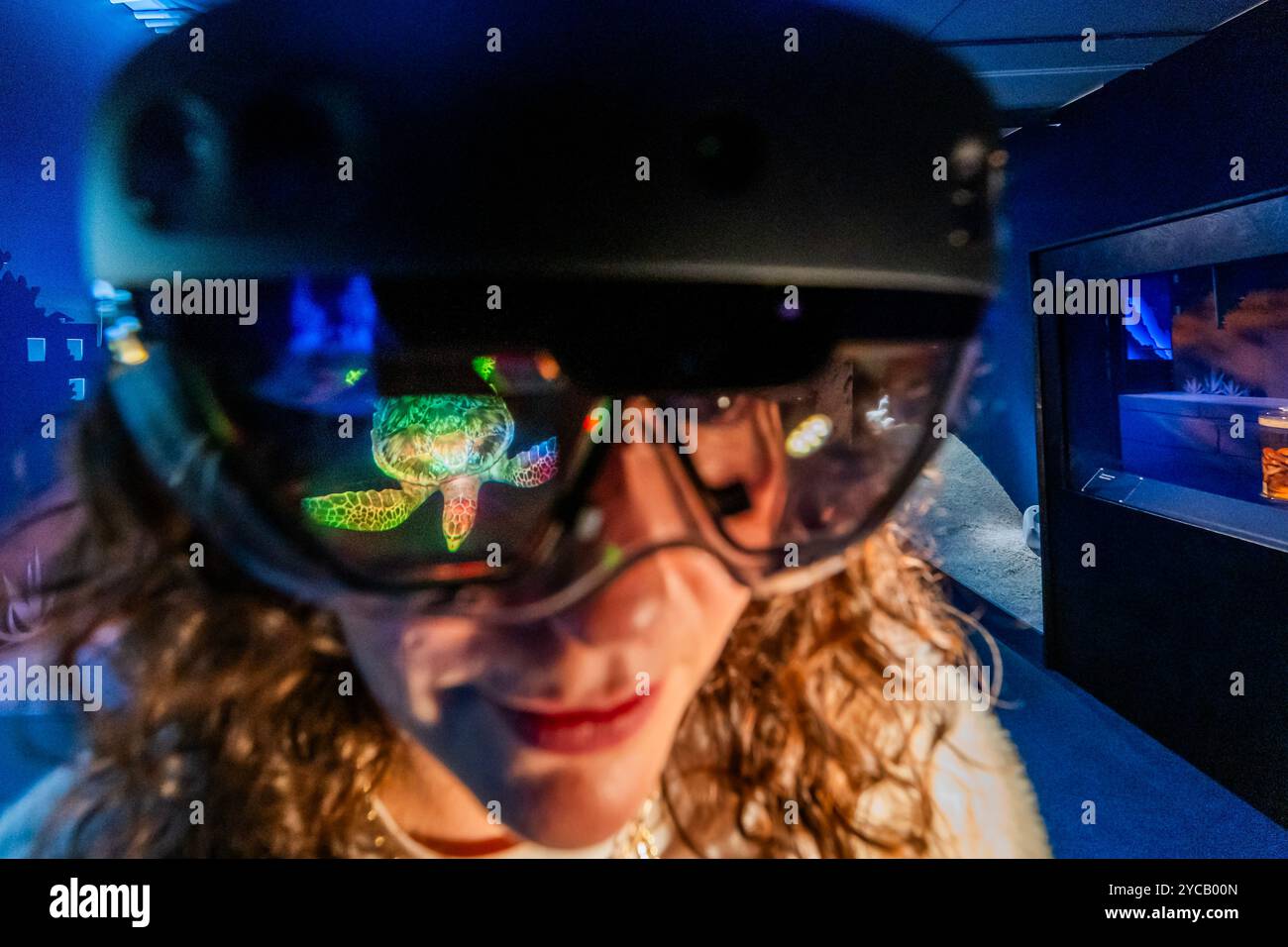 London, UK. 22nd Oct, 2024. A visitor watches a sea turtle swim in its ...