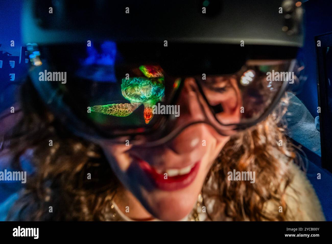 London, UK. 22nd Oct, 2024. A visitor watches a sea turtle swim in its ...