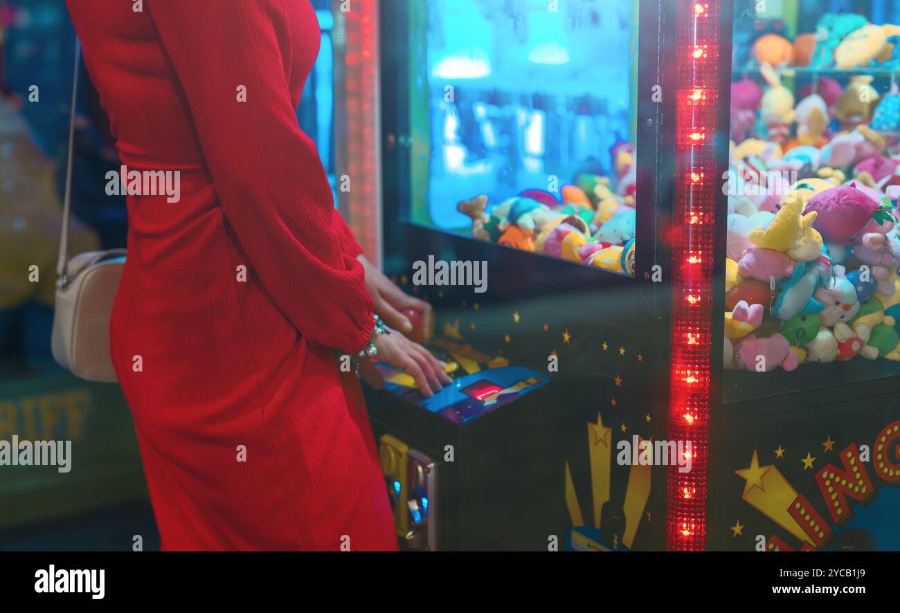Side, Turkey - 06.06.2024: Woman playing claw crane in theme park ...