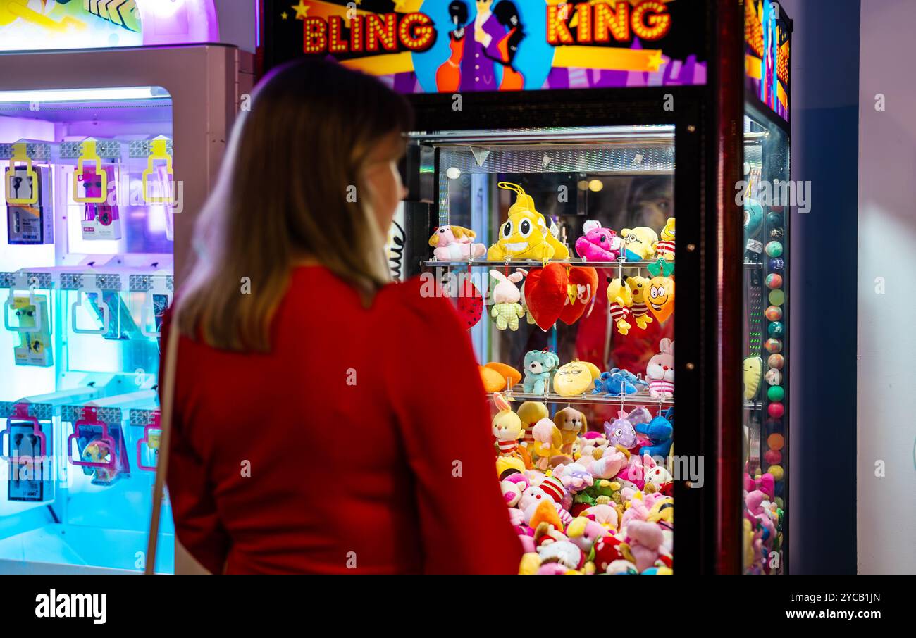Side, Turkey - 06.06.2024: Woman playing claw crane in theme park ...