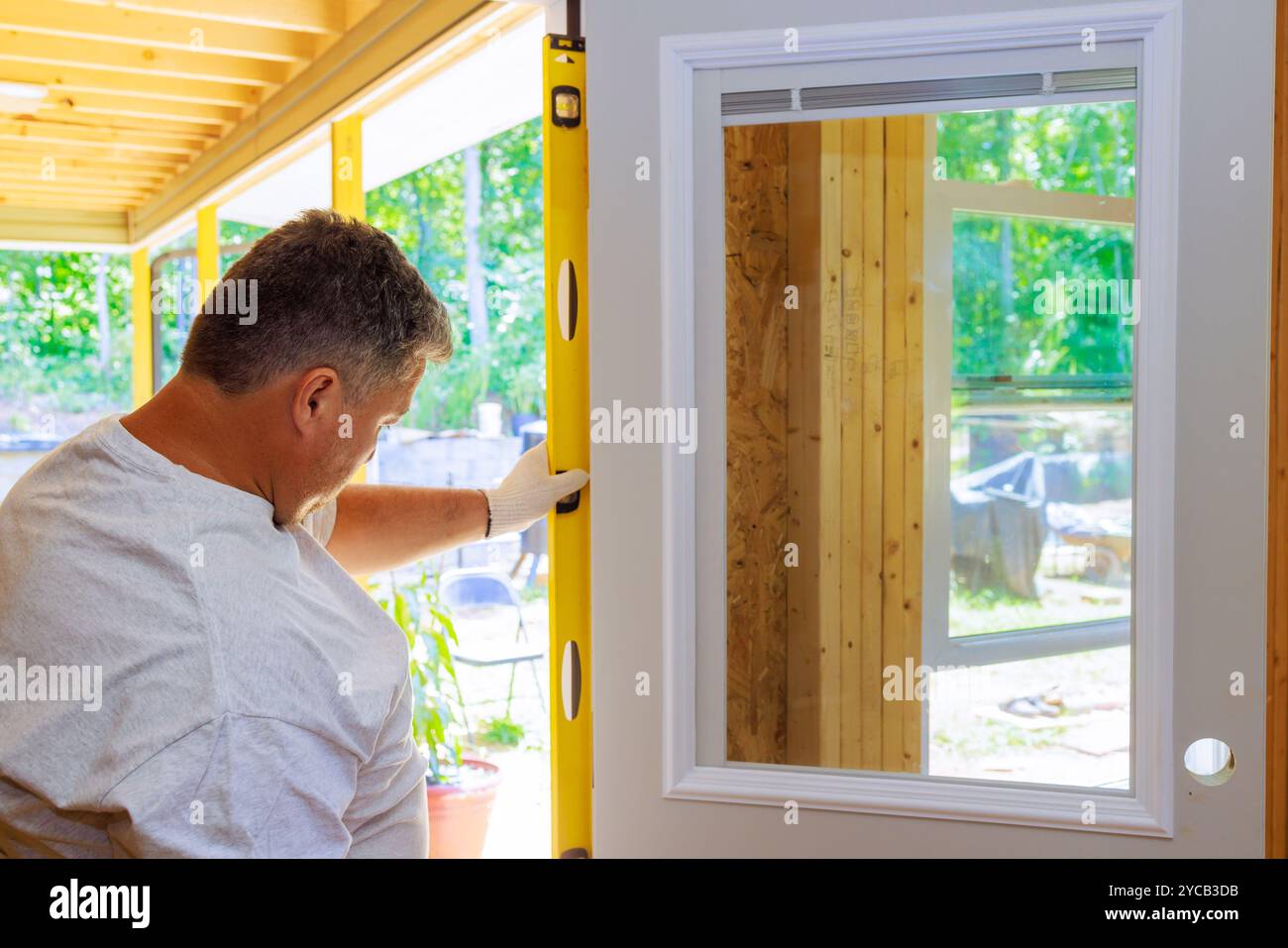 Front door of new home is installed by professional carpenter Stock ...