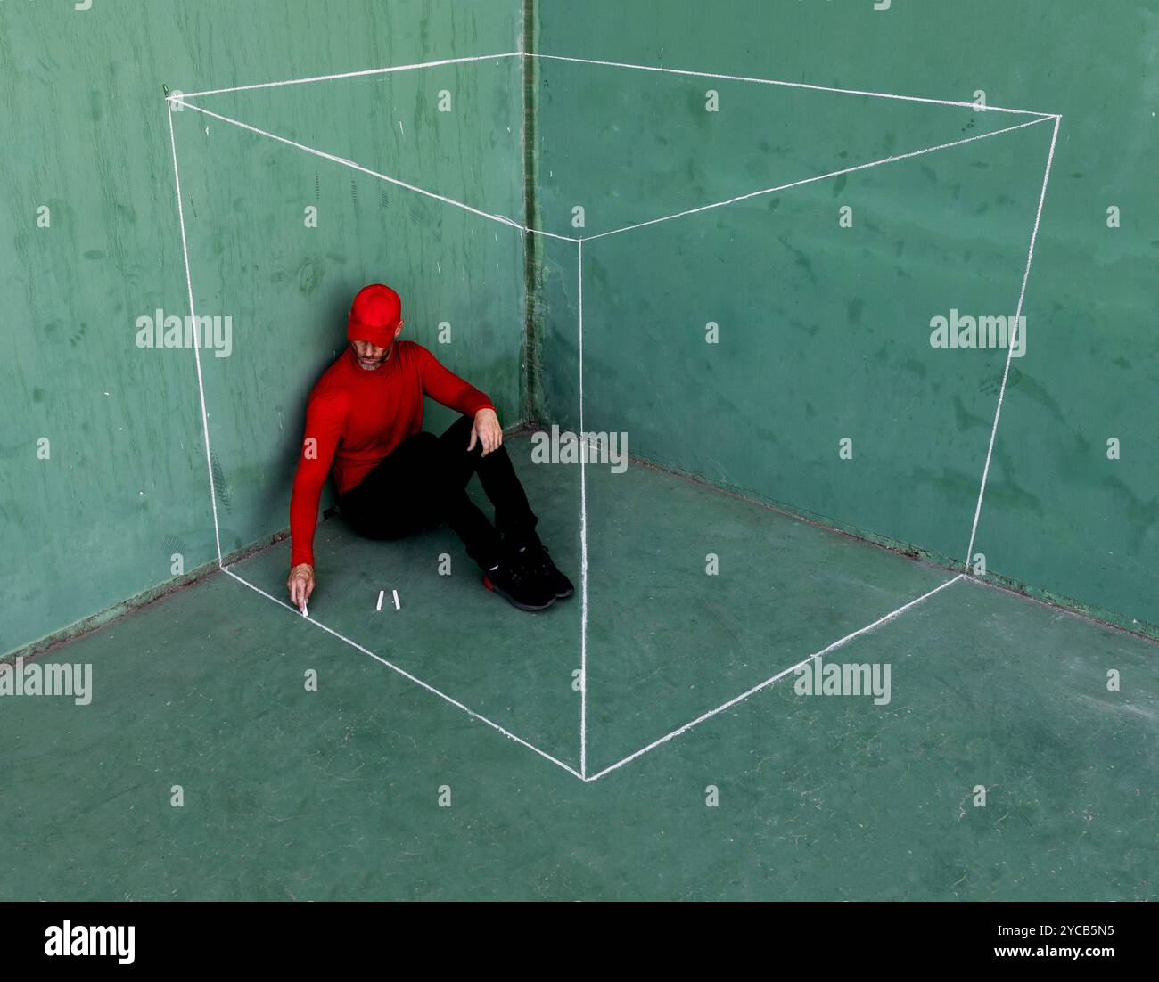 A man in a red outfit is depicted sitting inside a white outlined ...