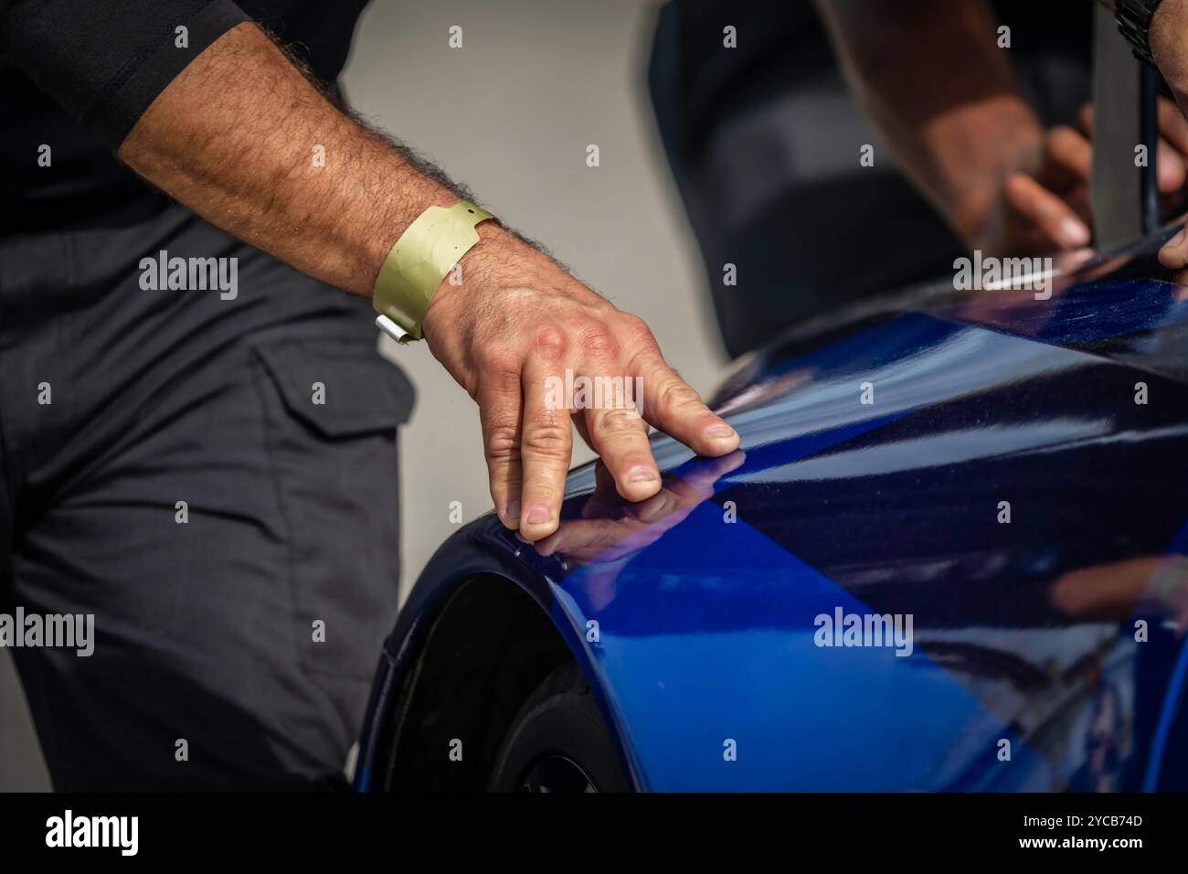 An engineer meticulously inspects the race car, fine-tuning key ... An engineer meticulously inspects the race car, fine-tuning key ...