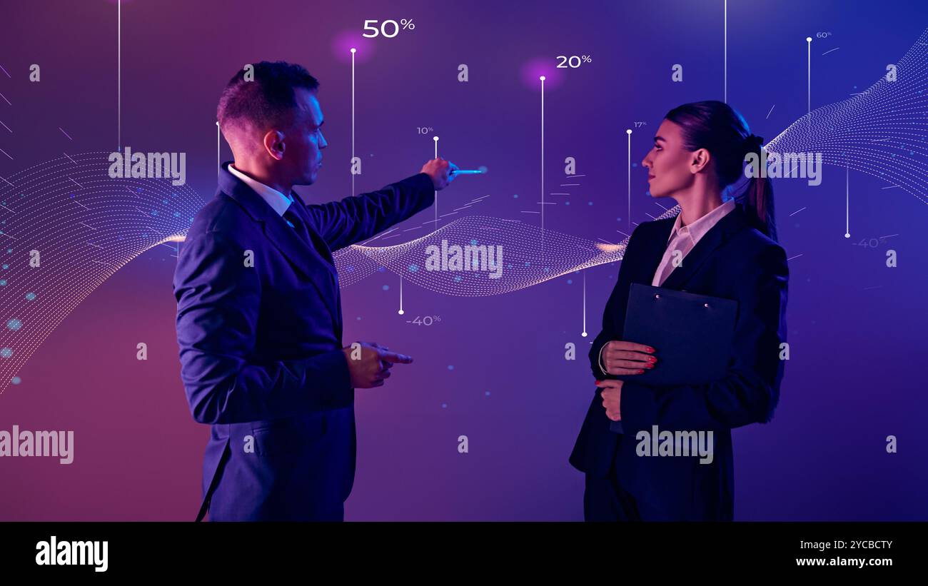 Corporate speaker with his assistant analyzes financial data trends ...
