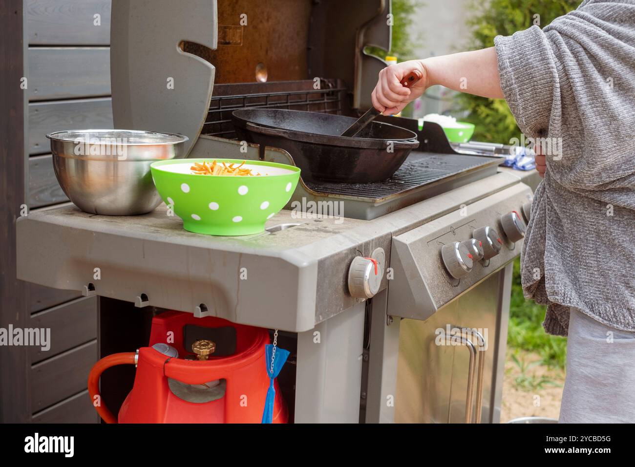a man cooking outdoor on a gas stove, daylight summertime shot Stock ...