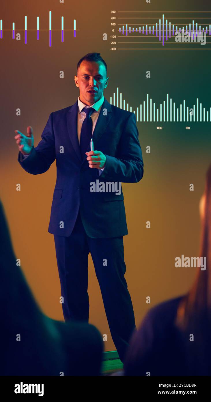 Young man presenter provides data analysis, pointing out essential ...