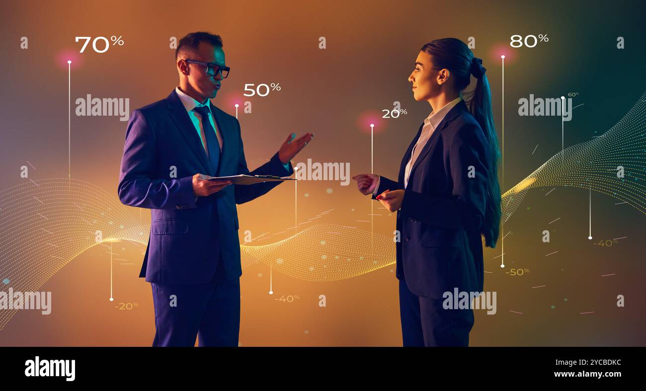 Business leader, with assistant presents key data trends with colorful ...