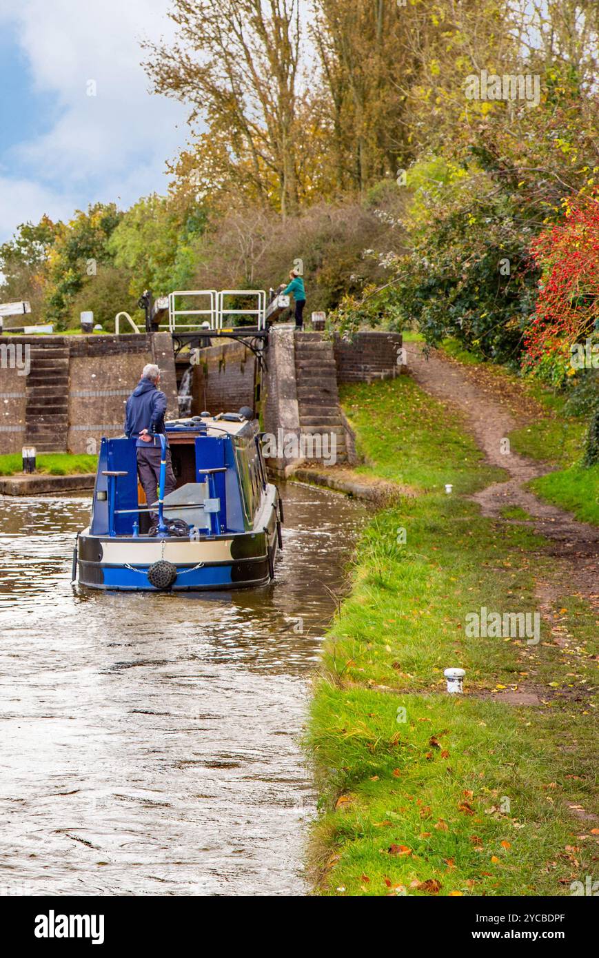 Canal narrowboat passing through locks on the Trent and Mersey canal as ...