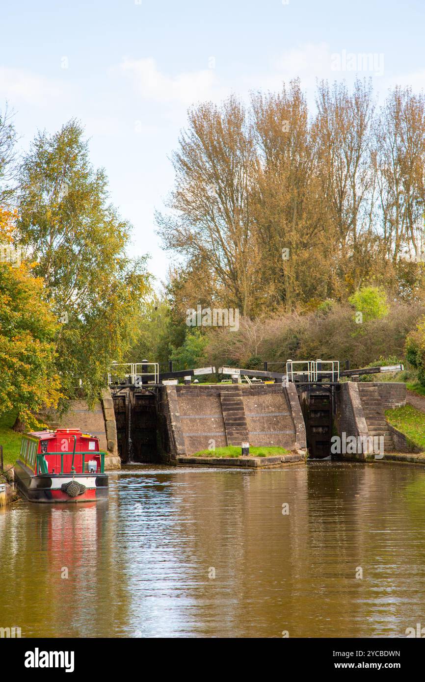 Canal narrowboat passing through locks on the Trent and Mersey canal as ...