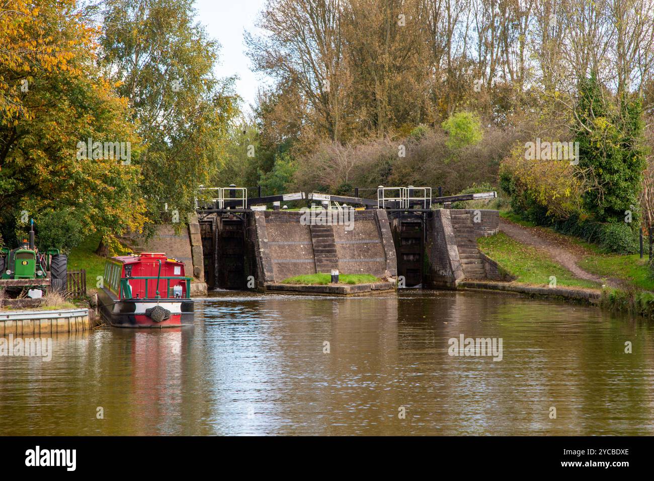 Canal narrowboat passing through locks on the Trent and Mersey canal as ...