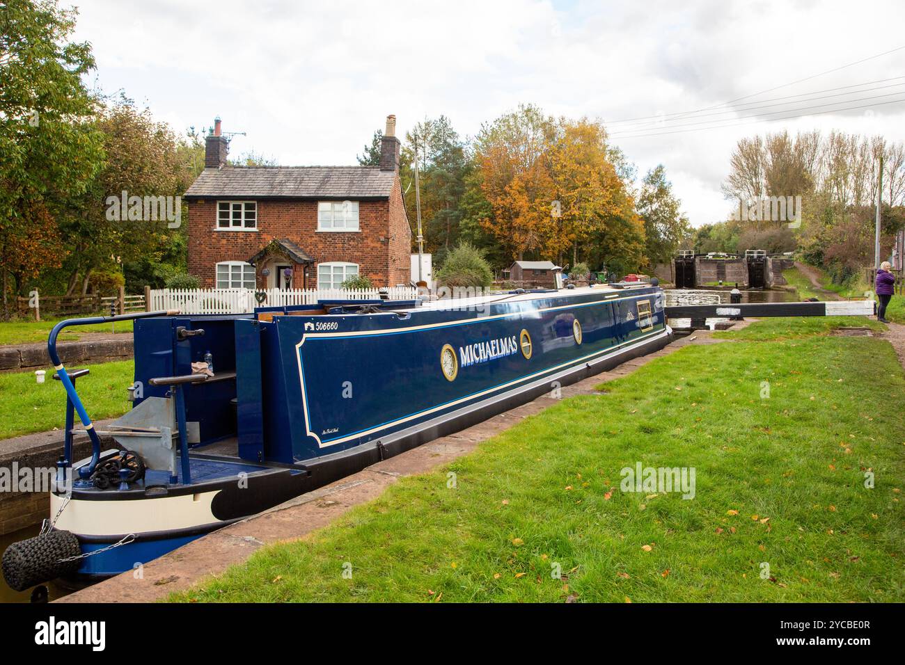 Canal narrowboat passing through locks on the Trent and Mersey canal as ...
