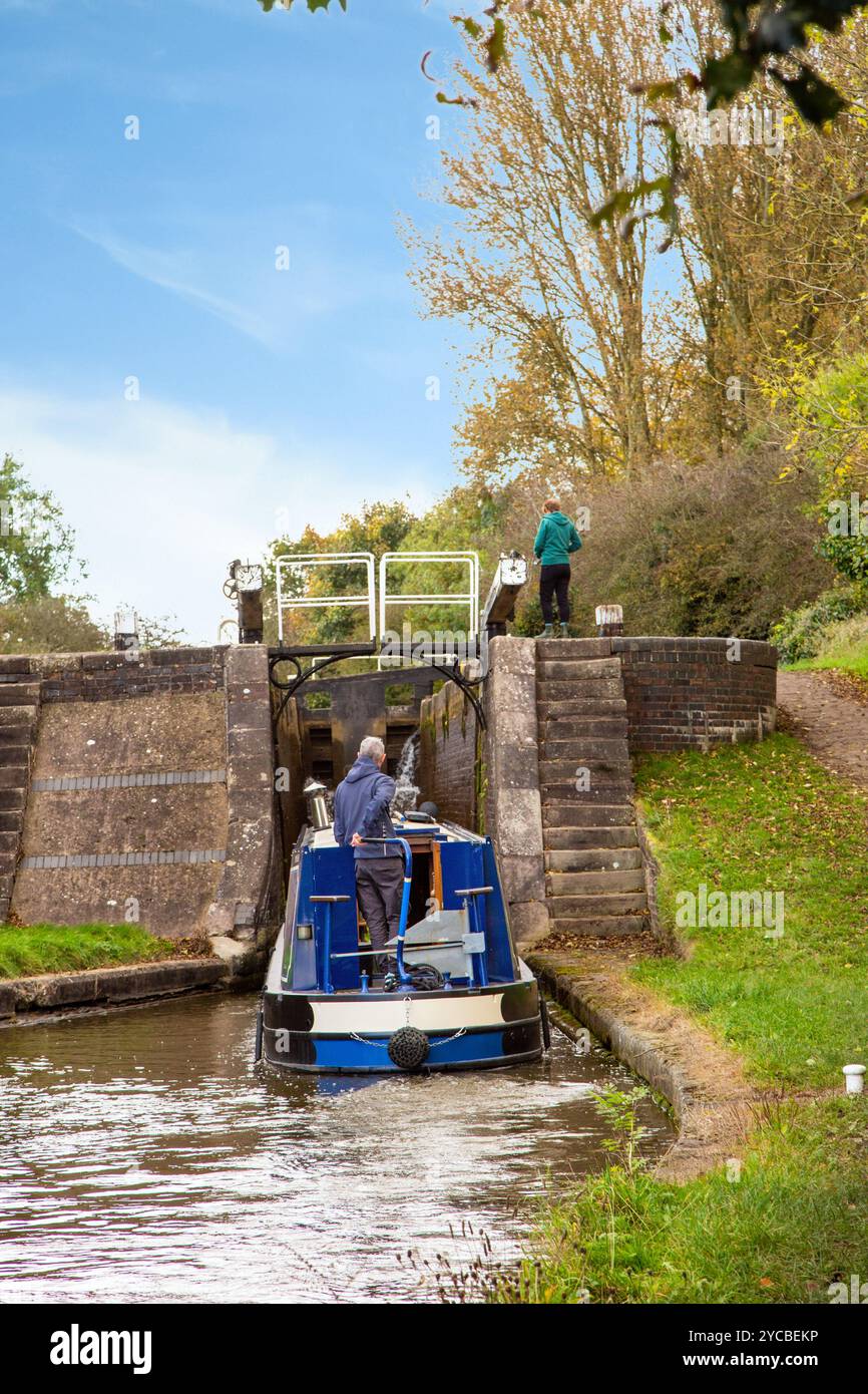 Canal narrowboat passing through locks on the Trent and Mersey canal as ...