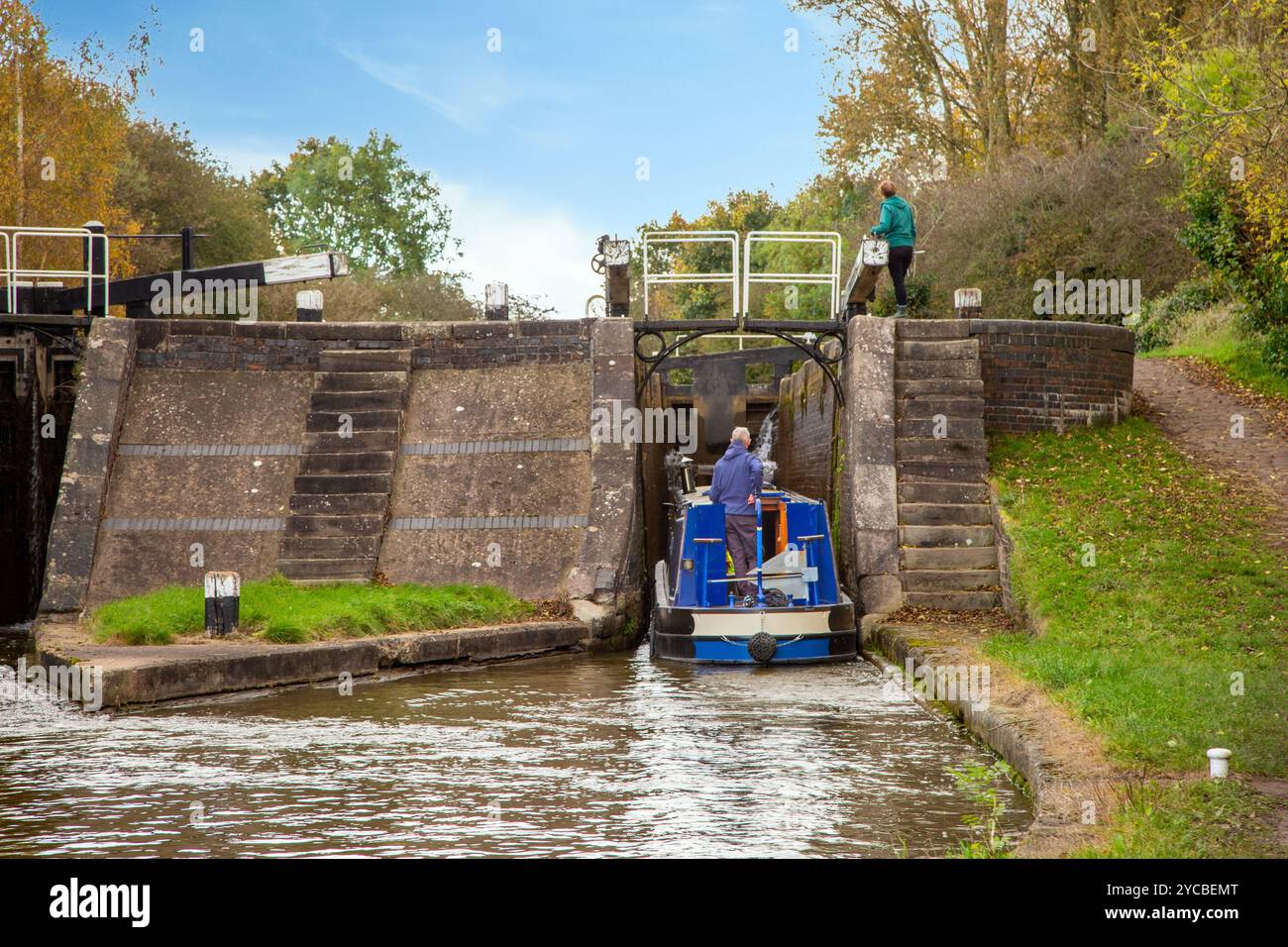 Canal narrowboat passing through locks on the Trent and Mersey canal as ...
