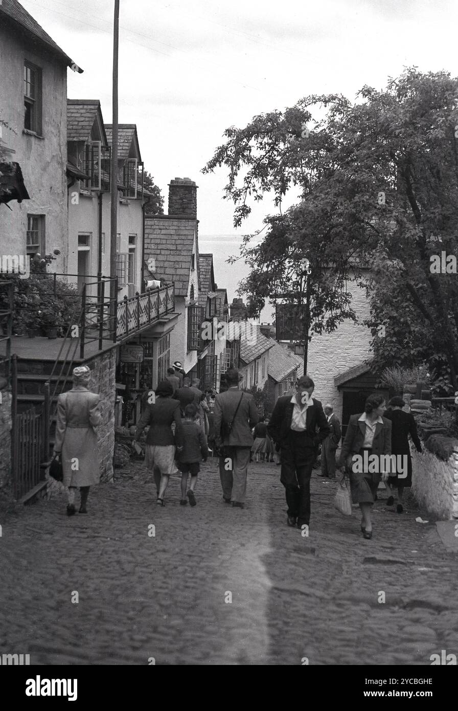 1950s, historical, people on the steep cobbled high street at the ...