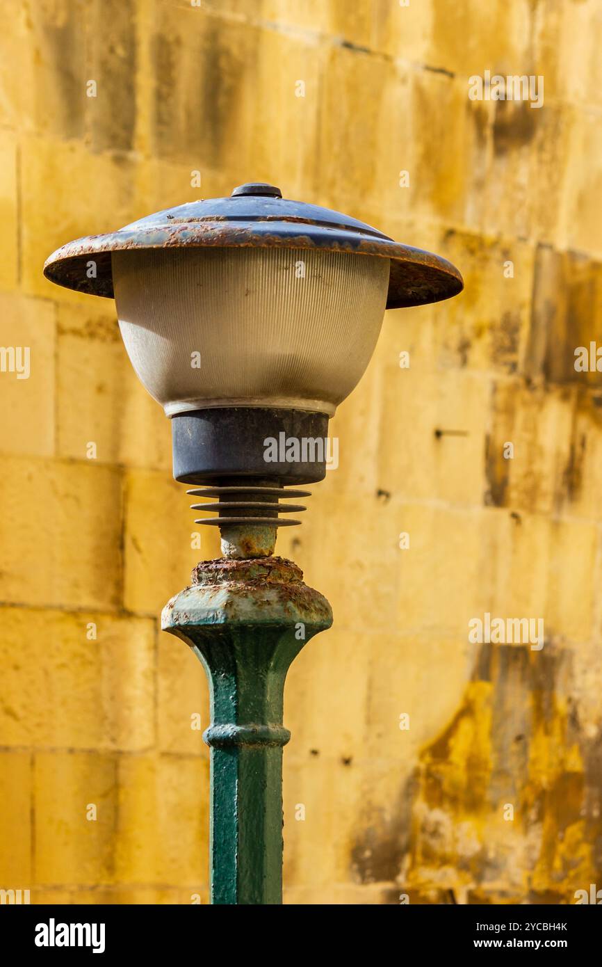Rustic Street Lamp Against Weathered Yellow Wall Stock Photo - Alamy