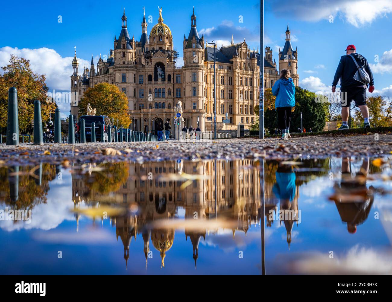 Schwerin, Germany. 22nd Oct, 2024. Passers-by walk along a footpath in ...