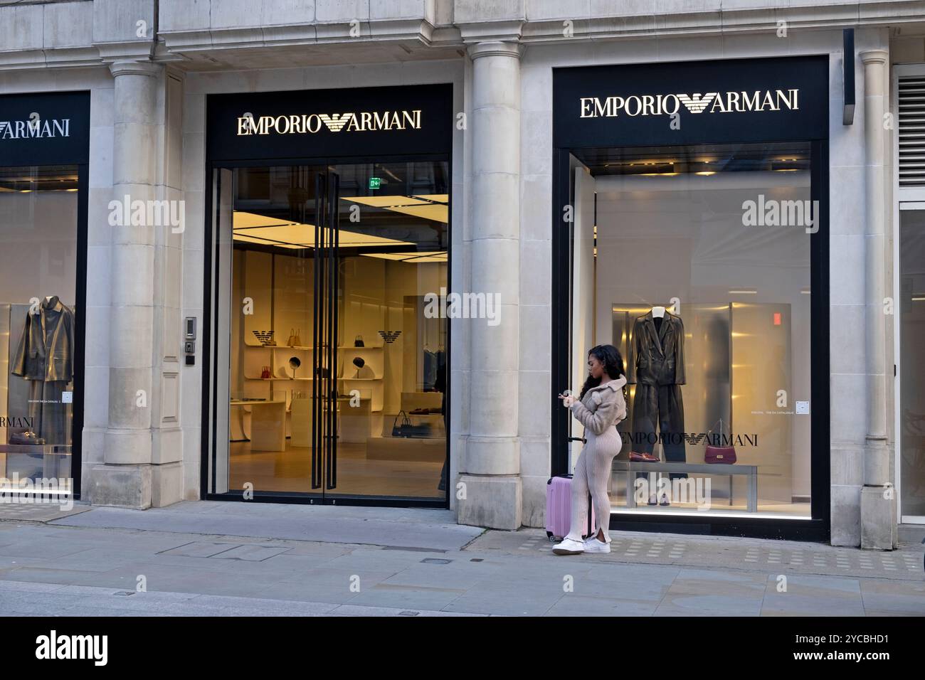 Emporio Armani store exterior window and young woman shopper on New ...